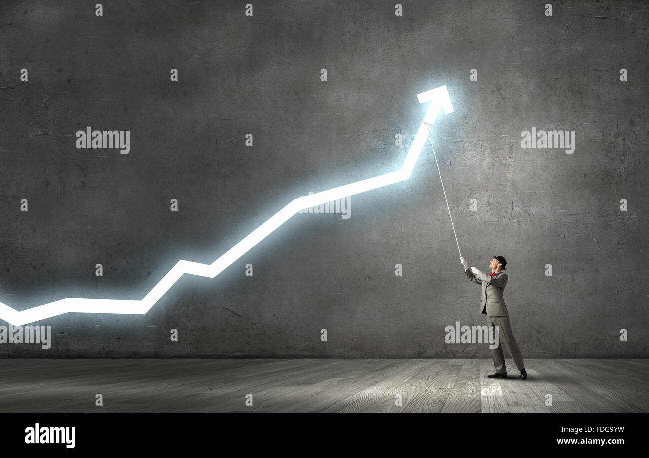 Businessman pulling arrow with rope and making it raise up Stock Photo ...