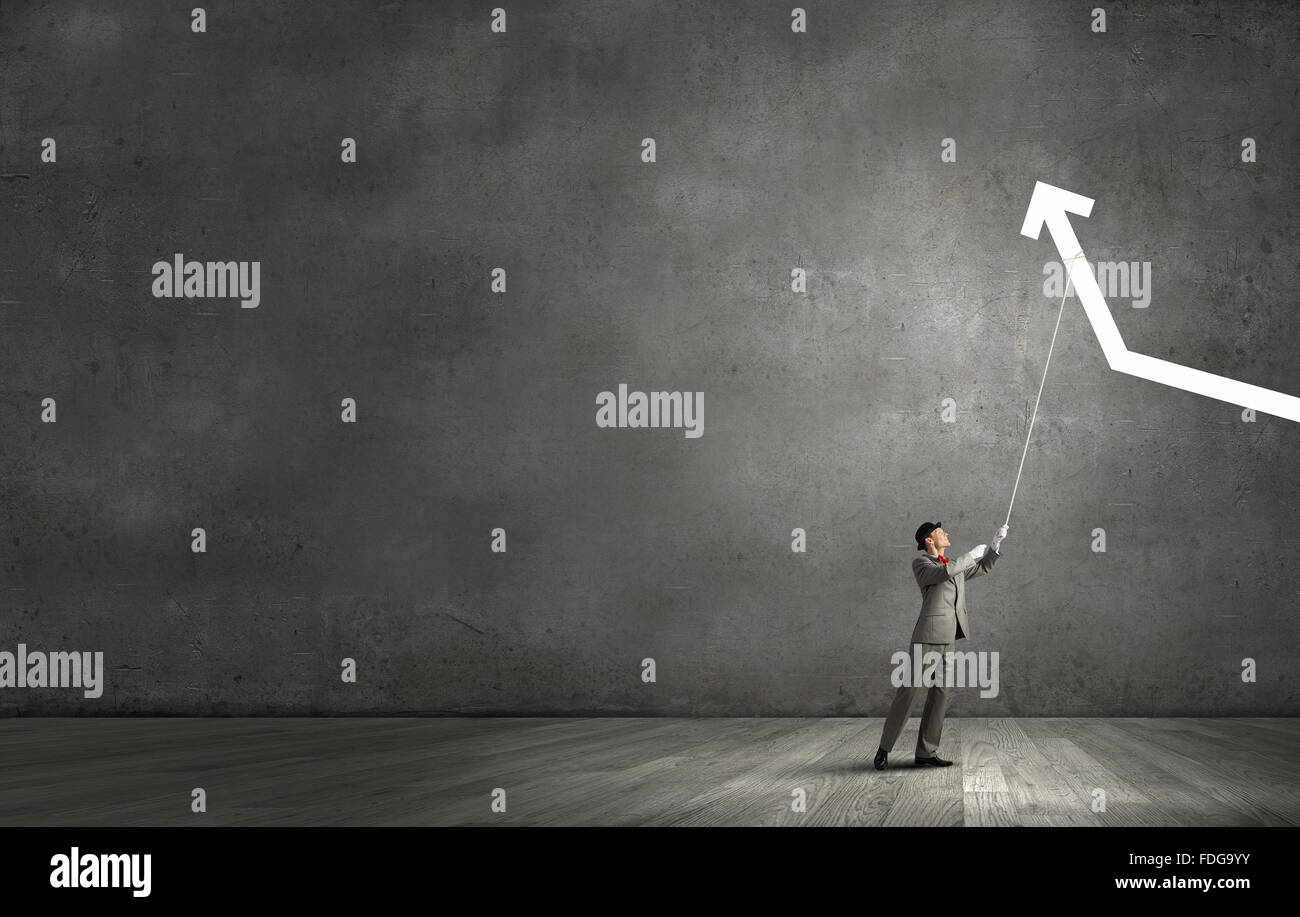 Businessman pulling arrow with rope and making it raise up Stock Photo ...
