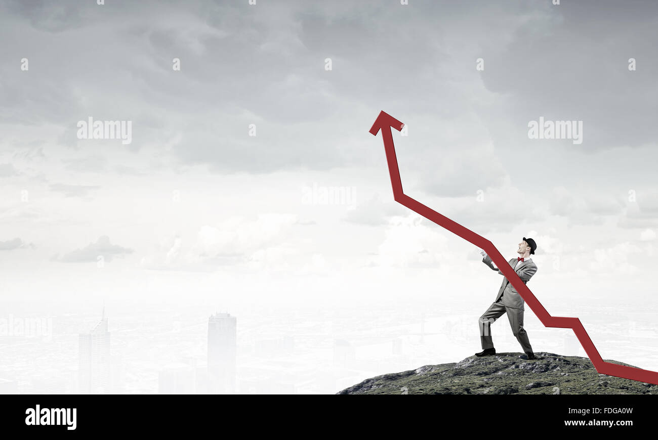 Businessman pulling arrow with rope and making it raise up Stock Photo ...