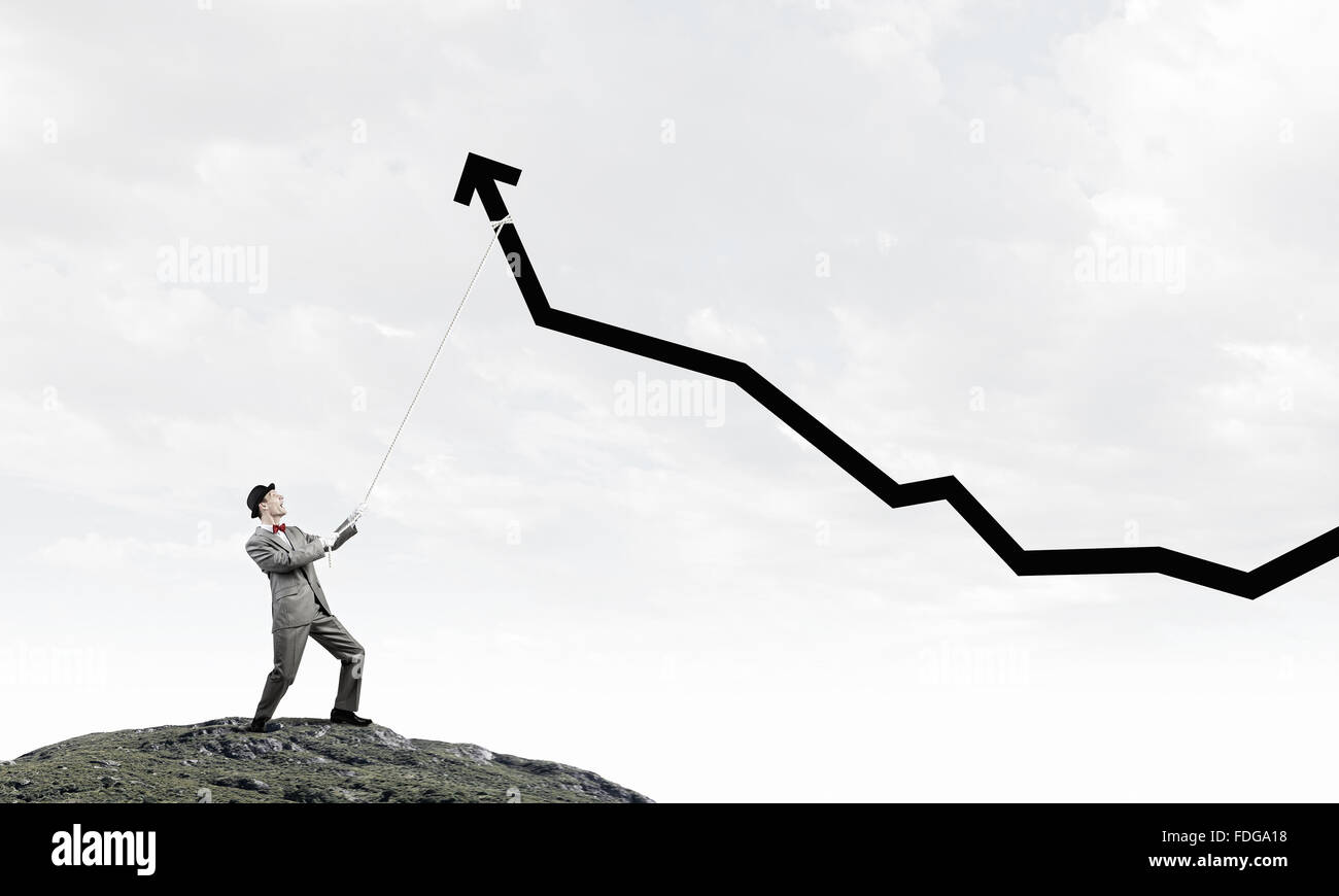 Businessman pulling arrow with rope and making it raise up Stock Photo ...