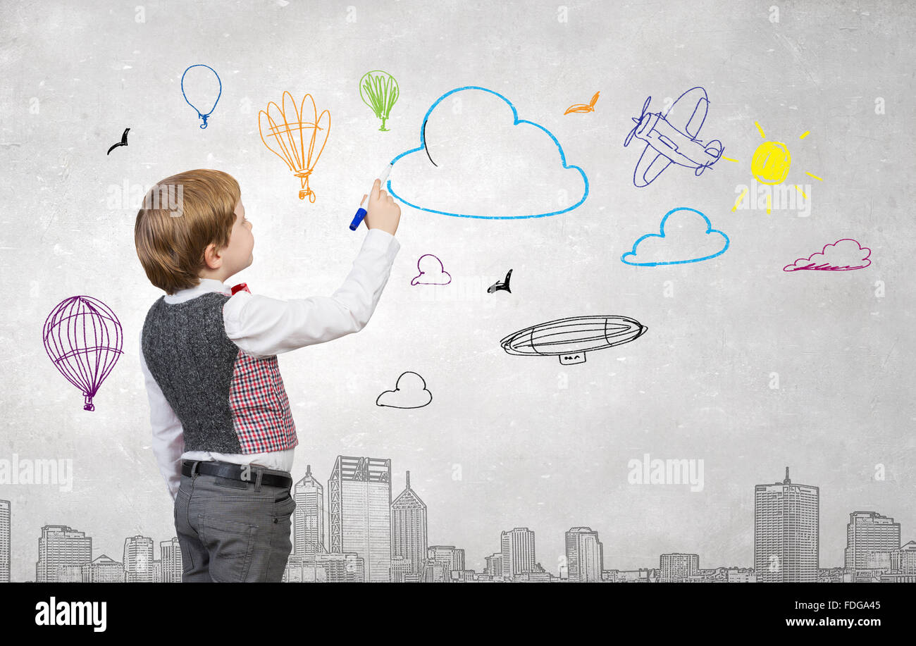 Adorable kid boy drawing with marker sketches on wall Stock Photo - Alamy