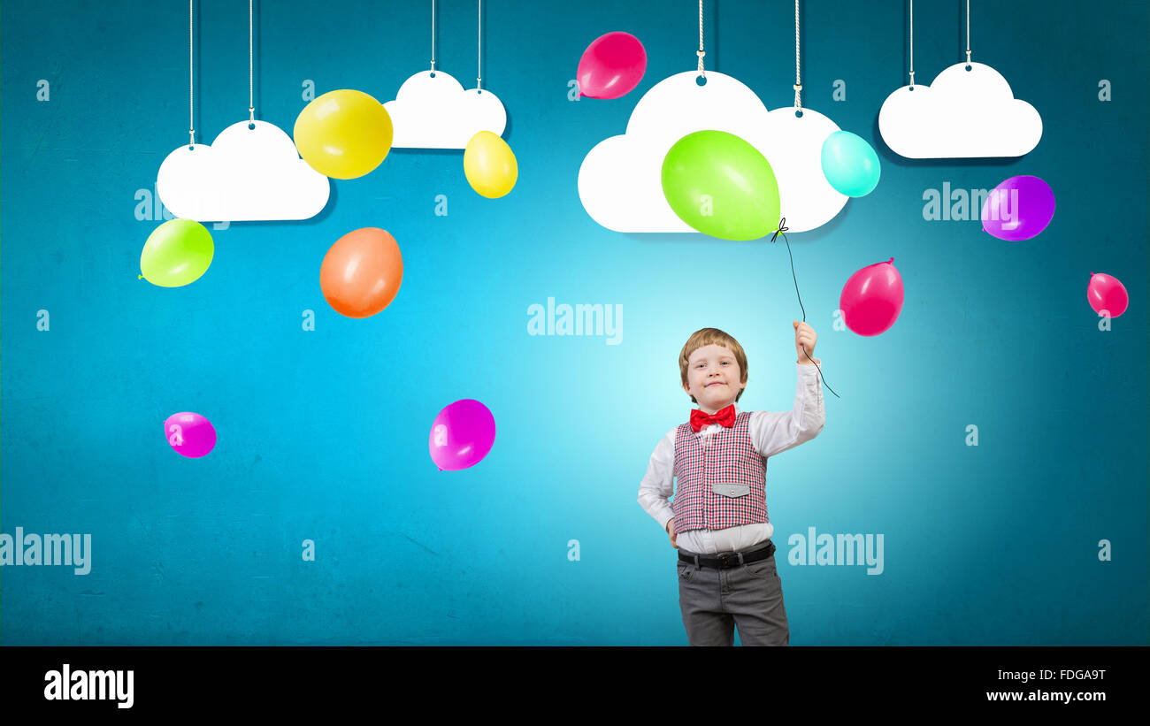 Little boy wearing red bowtie holding colorful balloon Stock Photo - Alamy