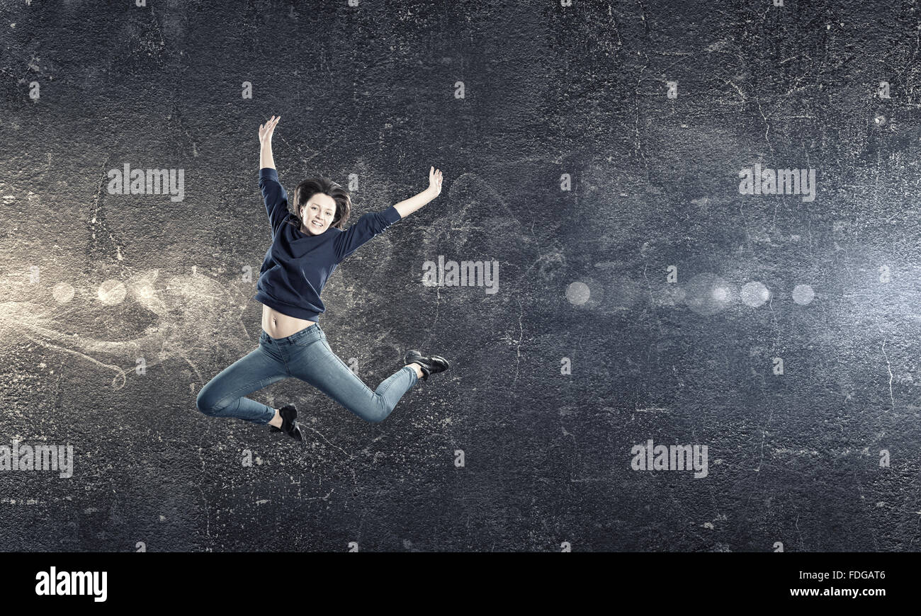 Young woman dancer jumping in spotlights on dark background Stock Photo ...