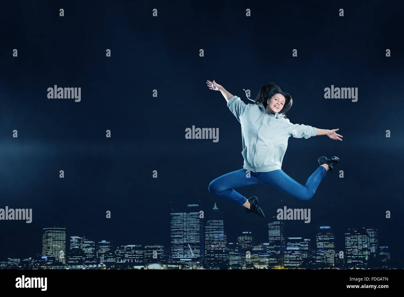 Young woman dancer jumping in spotlights on dark background Stock Photo ...