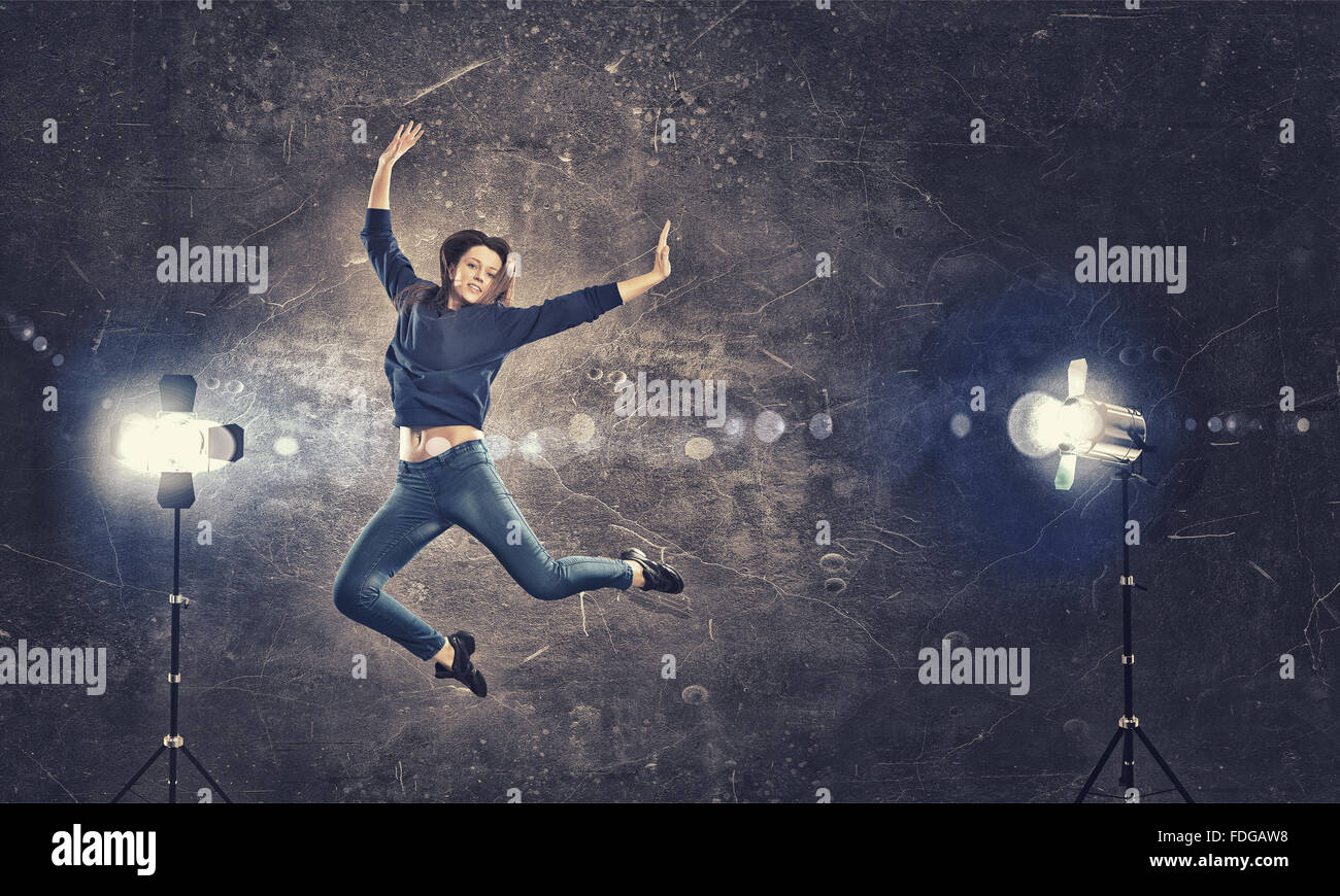 Young woman dancer jumping in spotlights on dark background Stock Photo ...