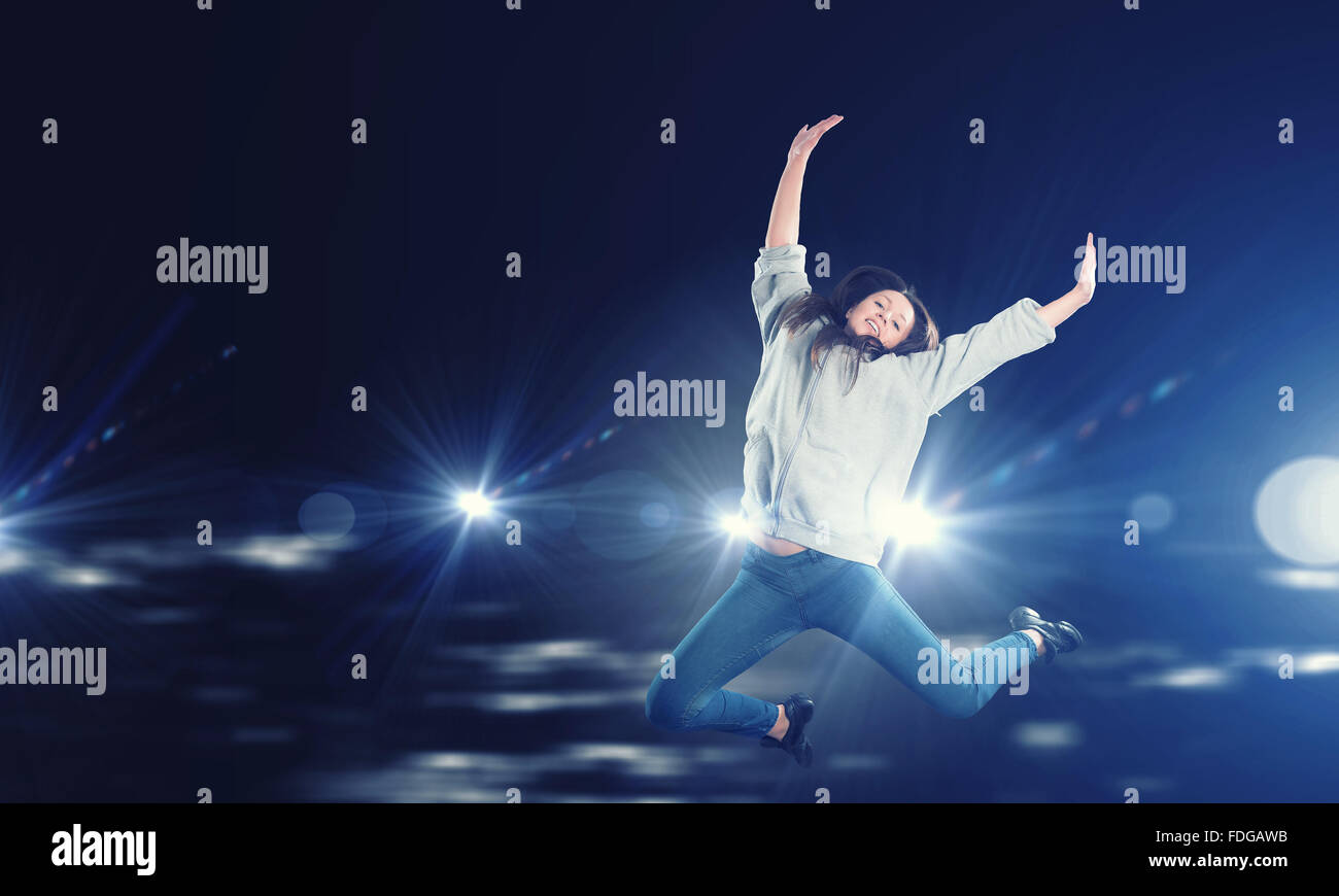 Young woman dancer jumping in spotlights on dark background Stock Photo ...