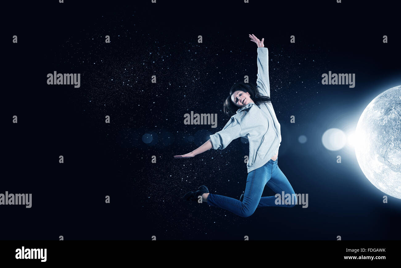 Young woman dancer jumping in spotlights on dark background Stock Photo ...