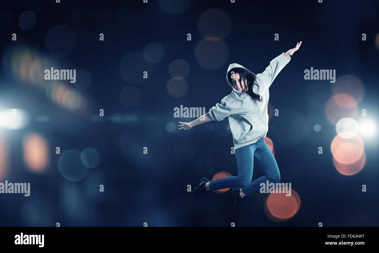 Young woman dancer jumping in spotlights on dark background Stock Photo ...