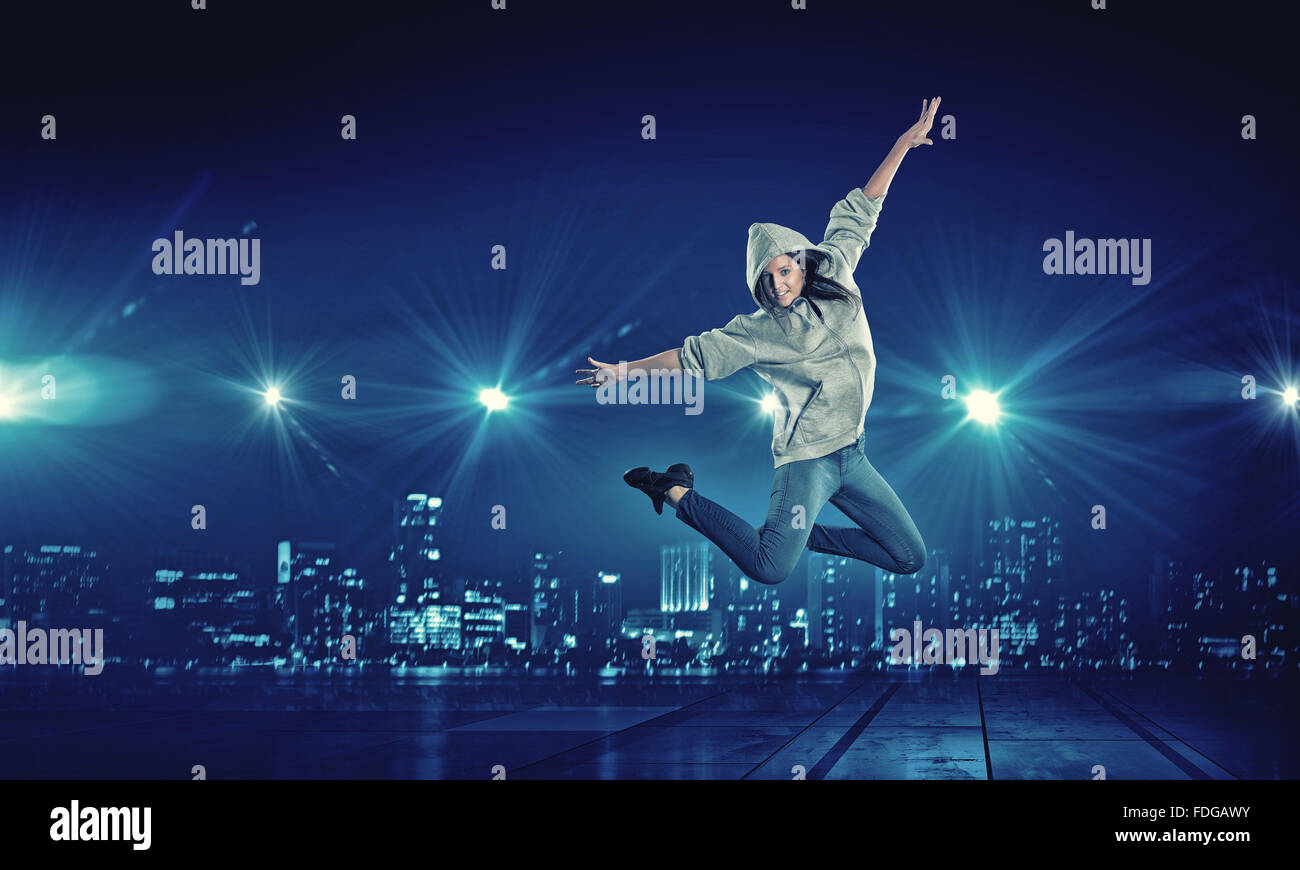 Young woman dancer jumping in spotlights on dark background Stock Photo ...