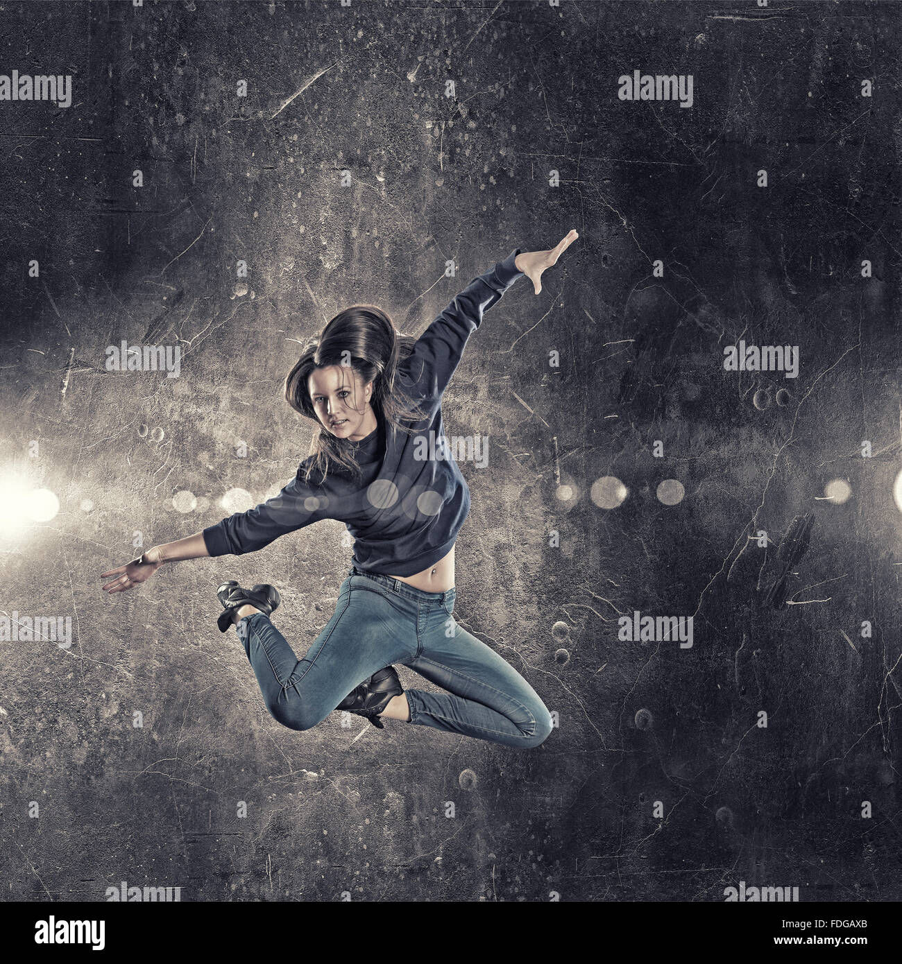 Young woman dancer jumping in spotlights on dark background Stock Photo ...