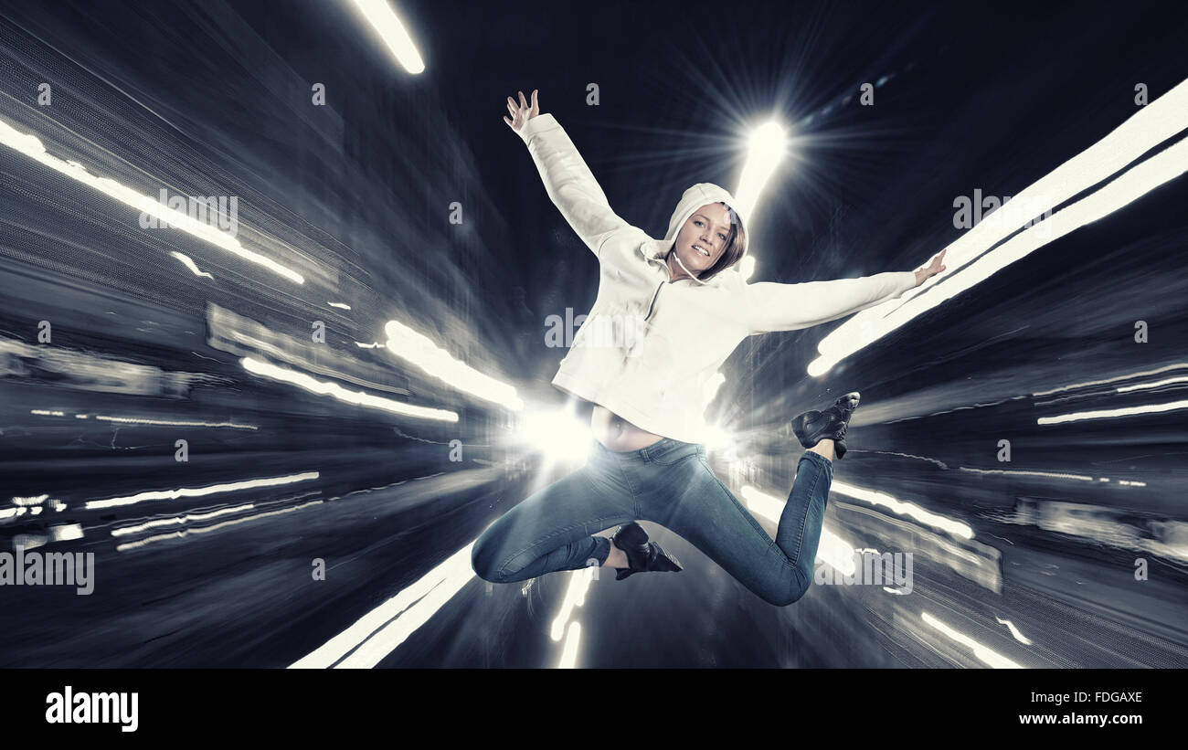 Young woman dancer jumping in spotlights on dark background Stock Photo ...