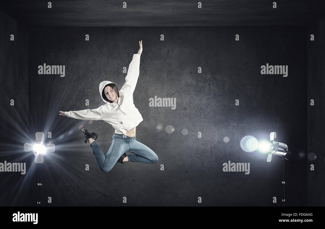 Young woman dancer jumping in spotlights on dark background Stock Photo ...