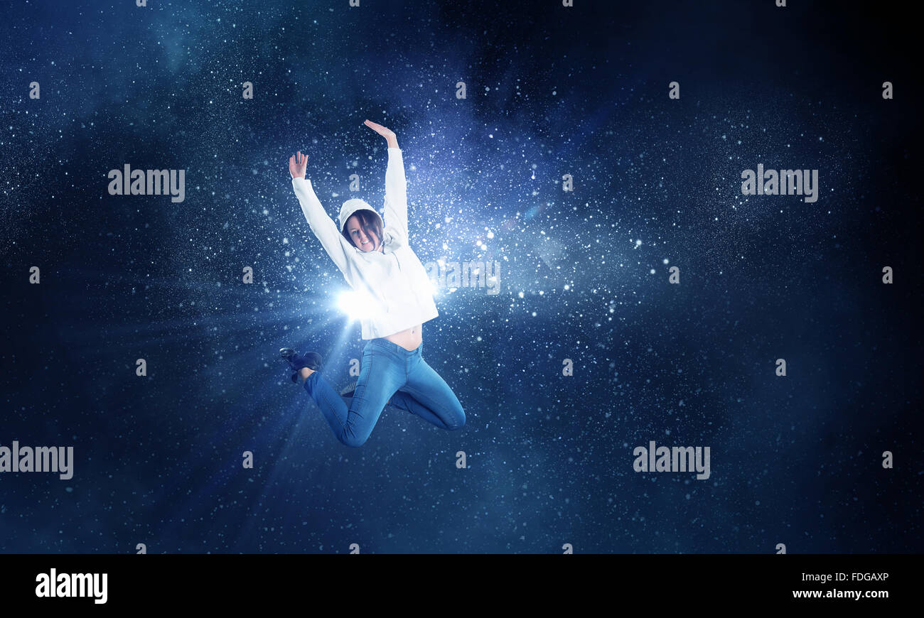 Young woman dancer jumping in spotlights on dark background Stock Photo ...