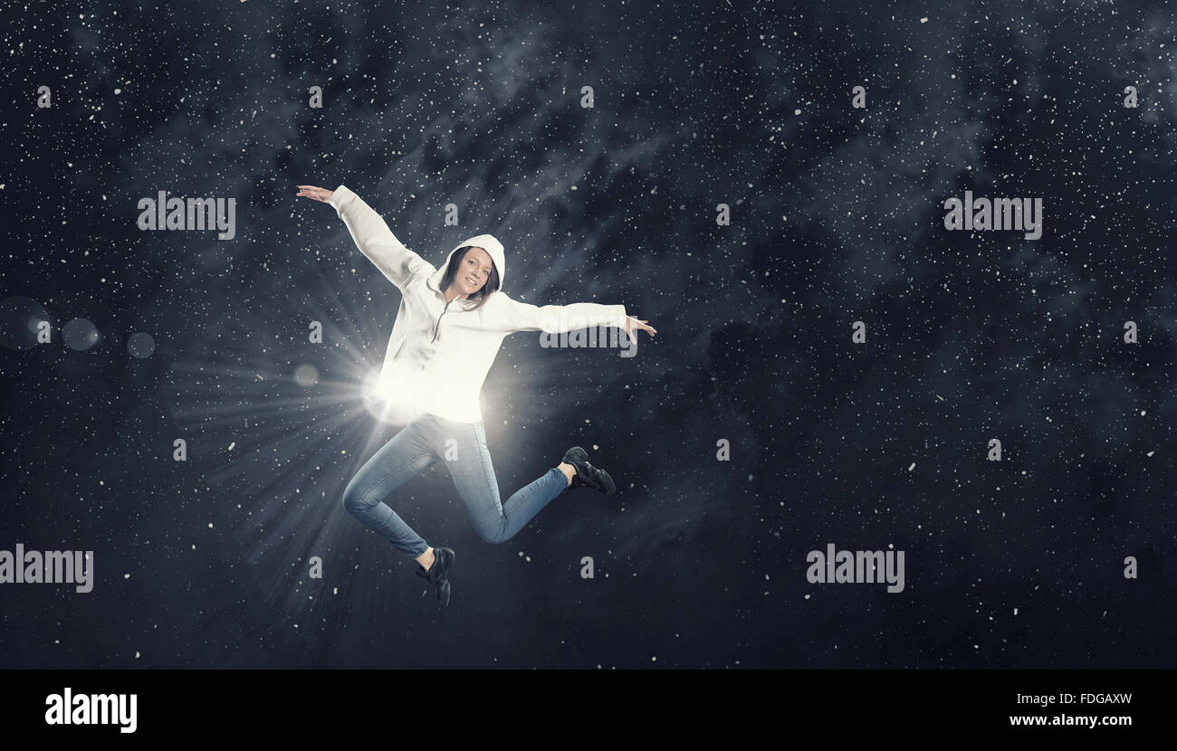 Young woman dancer jumping in spotlights on dark background Stock Photo ...