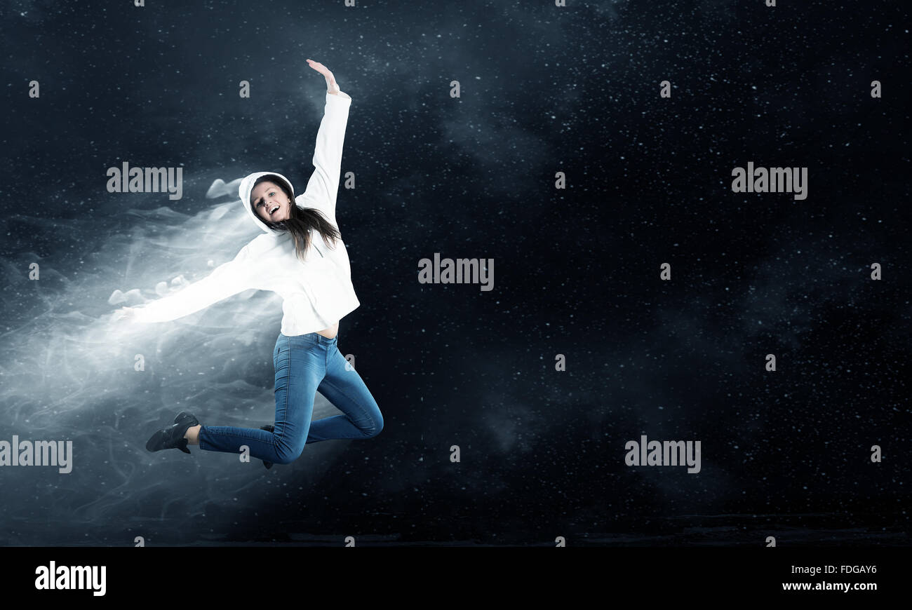 Young woman dancer jumping in spotlights on dark background Stock Photo ...
