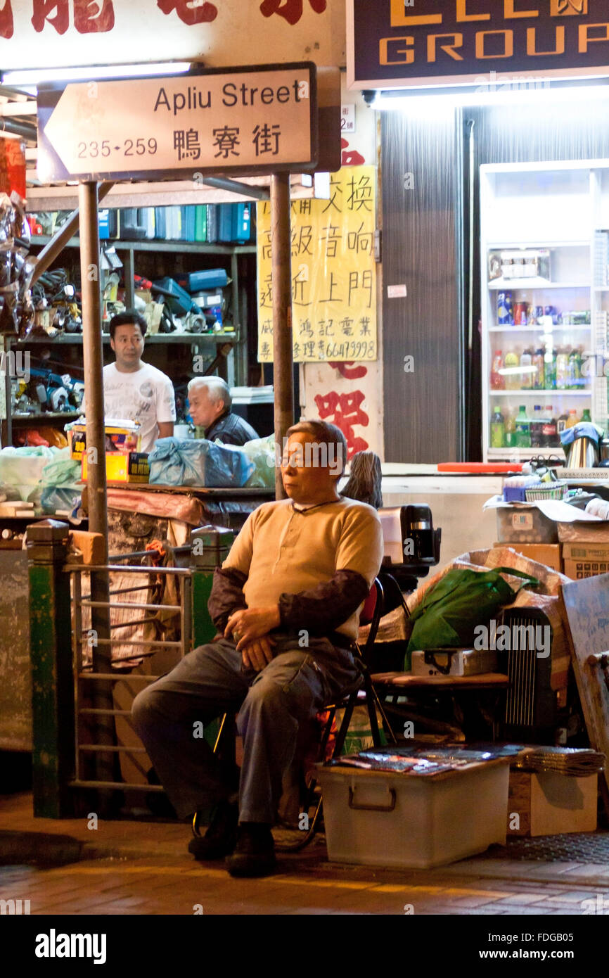 HONG KONG - FEB 16, A Chinese hawker in Apliu Street, Hong Kong on 16 ...