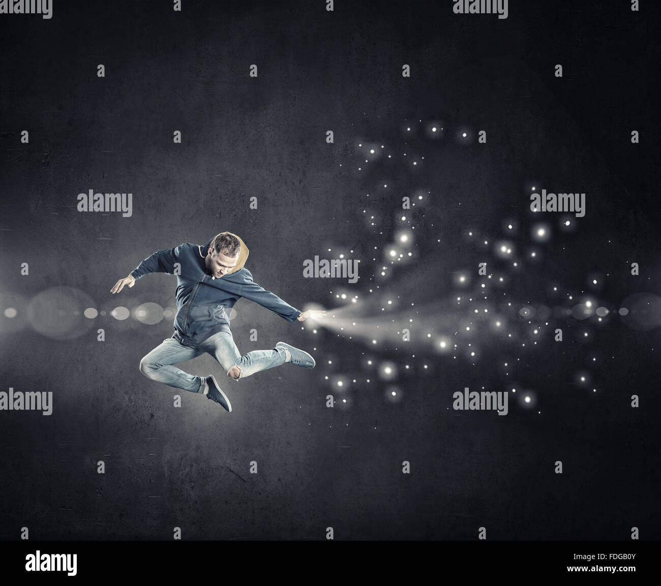 Modern style male dancer jumping in lights of spotlight Stock Photo - Alamy