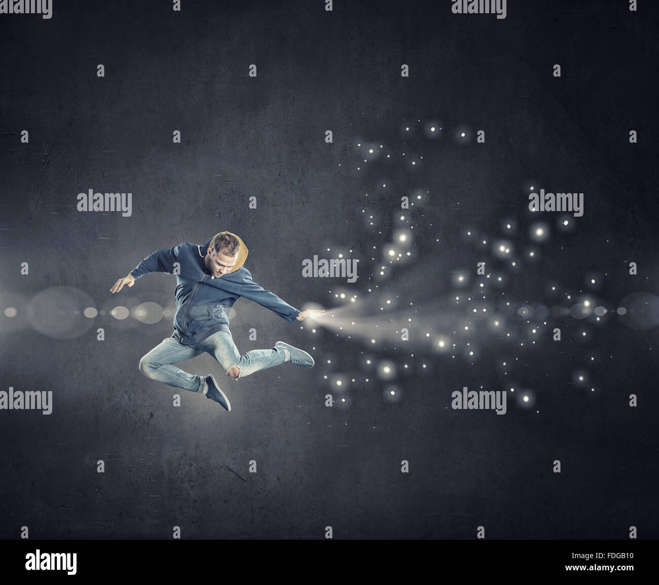 Modern style male dancer jumping in lights of spotlight Stock Photo - Alamy
