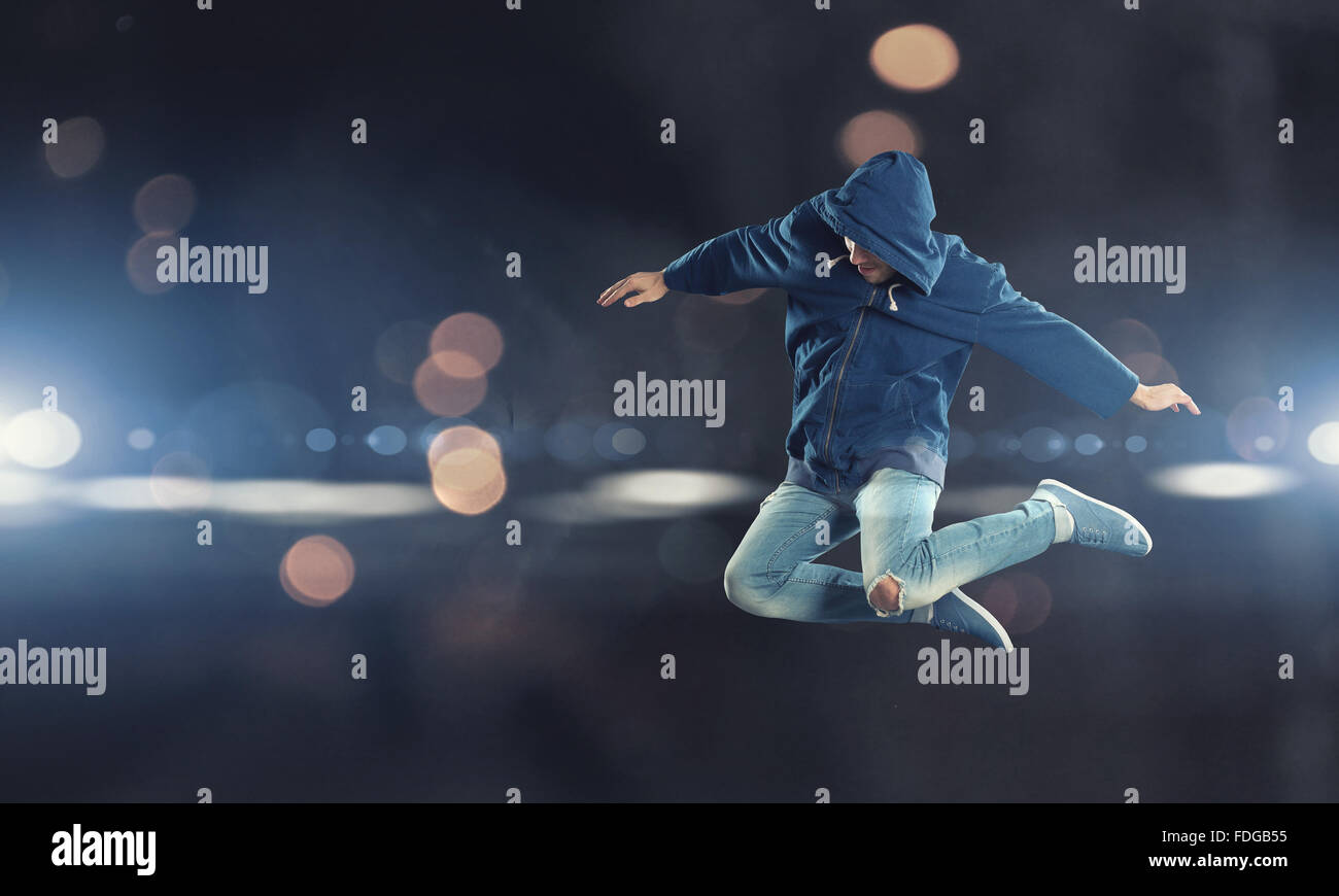 Modern style male dancer jumping in lights of spotlight Stock Photo - Alamy