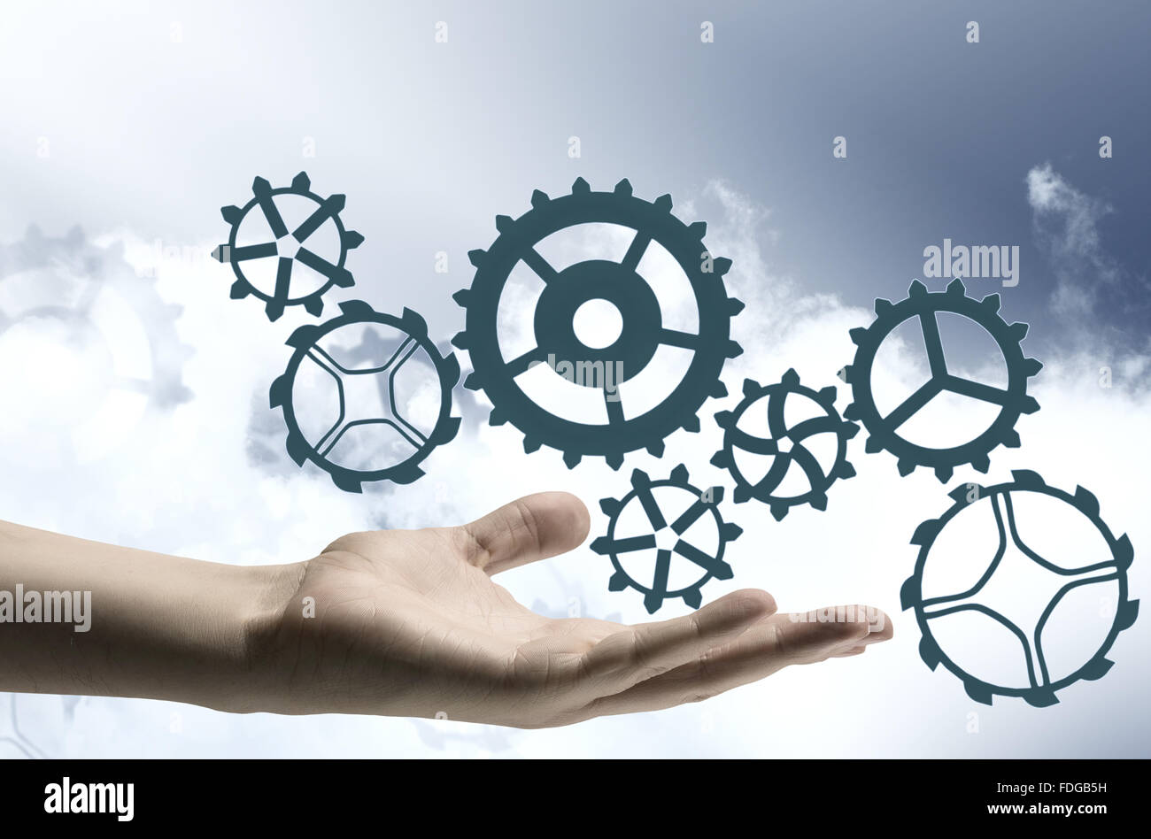 Close up human hand holding gears mechanism Stock Photo - Alamy