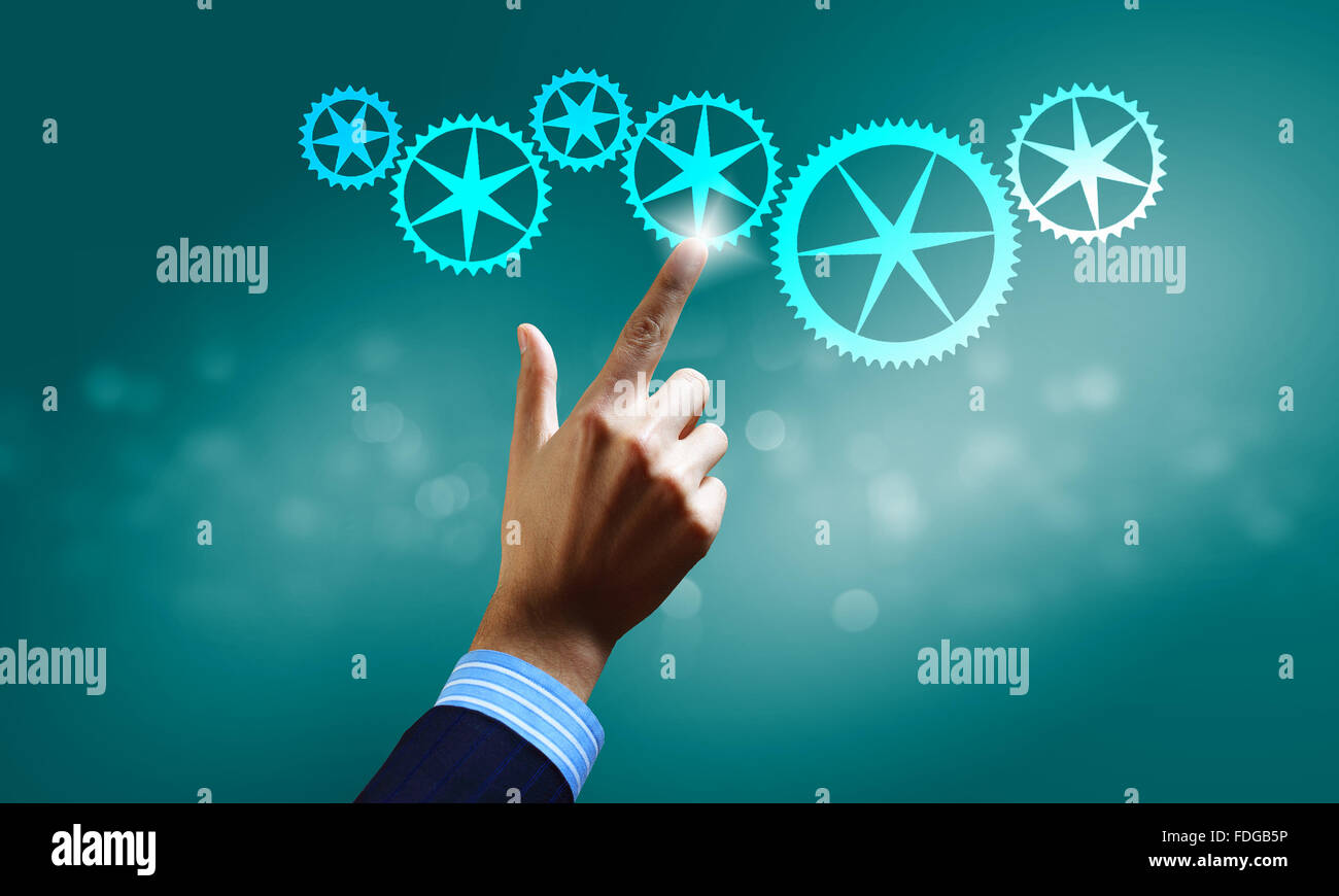 Close up human hand pointing with finger at gears mechanism Stock Photo ...