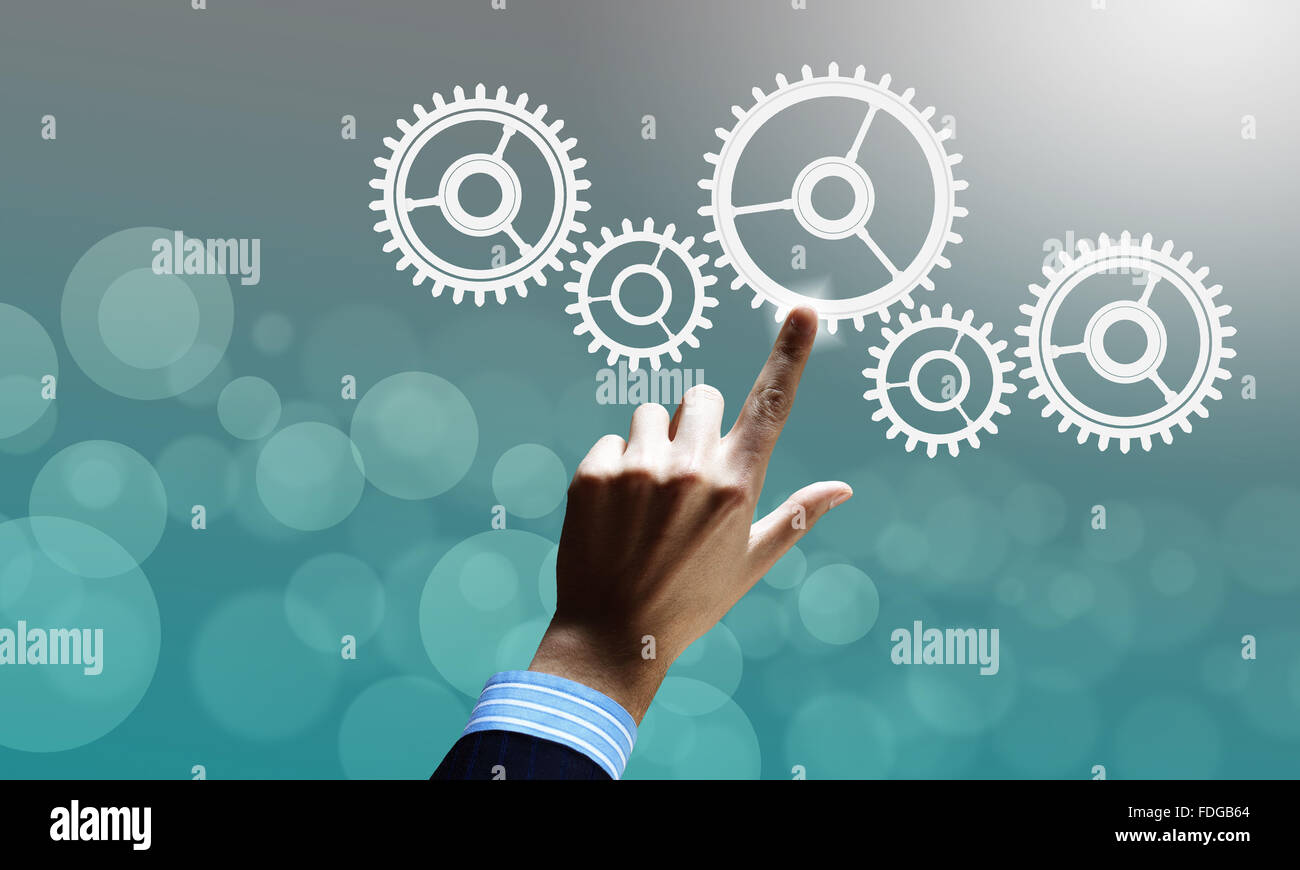 Close up human hand pointing with finger at gears mechanism Stock Photo ...