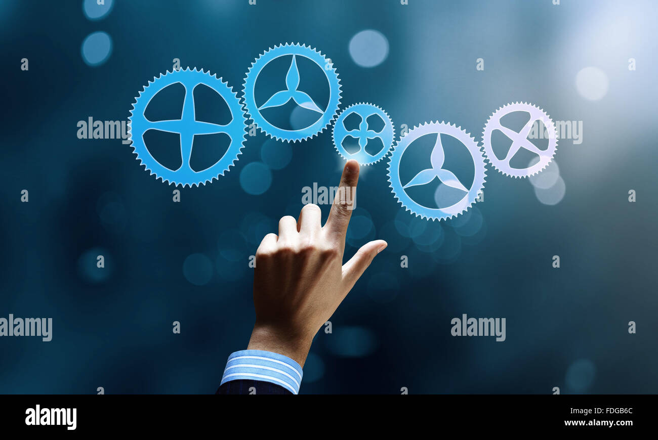Close up human hand pointing with finger at gears mechanism Stock Photo ...