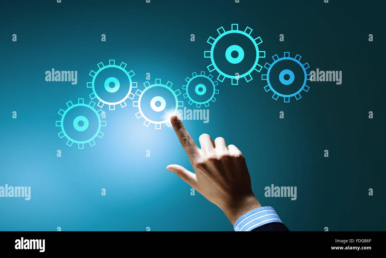 Close up human hand pointing with finger at gears mechanism Stock Photo ...