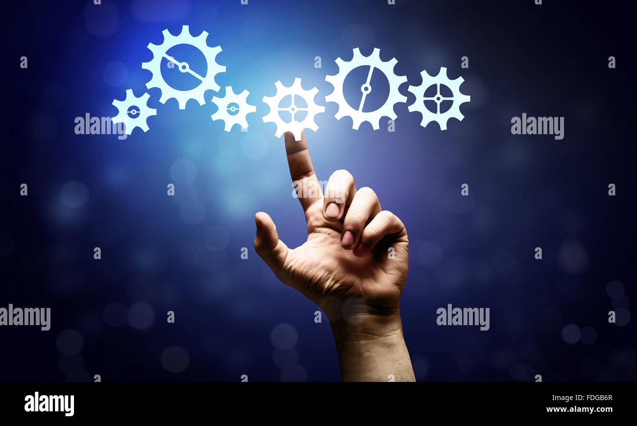 Close up human hand pointing with finger at gears mechanism Stock Photo ...