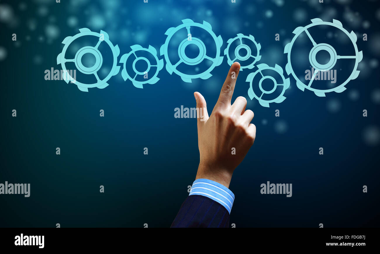 Close up human hand pointing with finger at gears mechanism Stock Photo ...