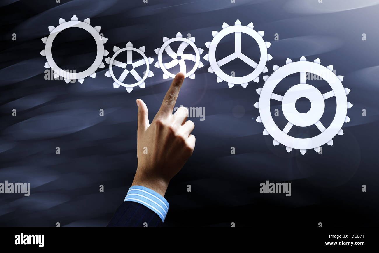 Close up human hand pointing with finger at gears mechanism Stock Photo ...