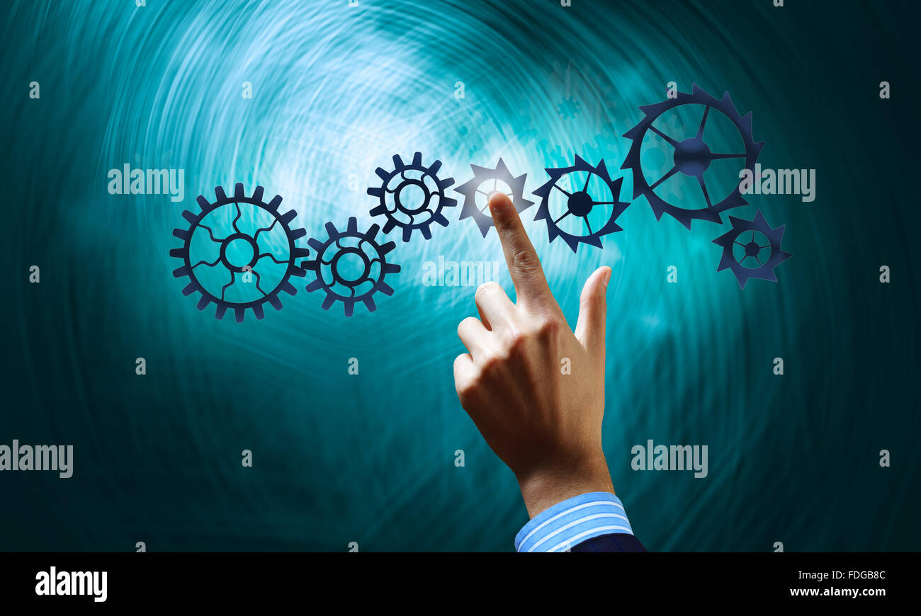 Close up human hand pointing with finger at gears mechanism Stock Photo ...