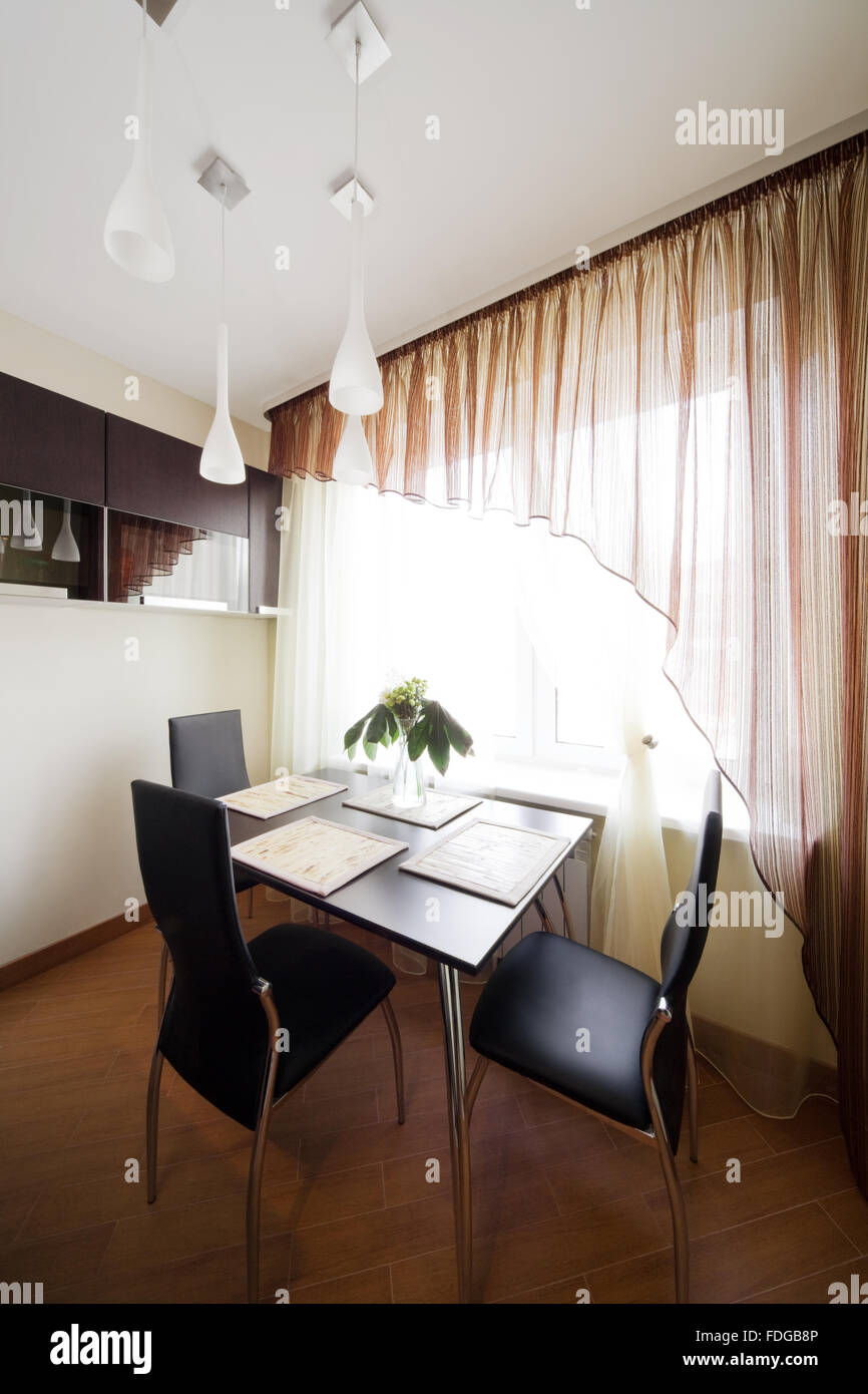 table and chairs by the window on the modern kitchen Stock Photo - Alamy