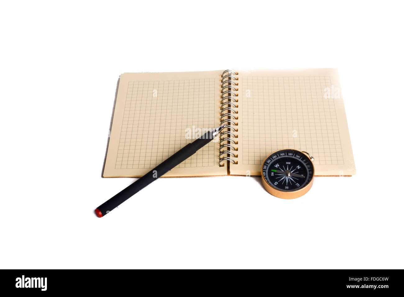 Spiral notebook and poll point pen and compass on a white background ...