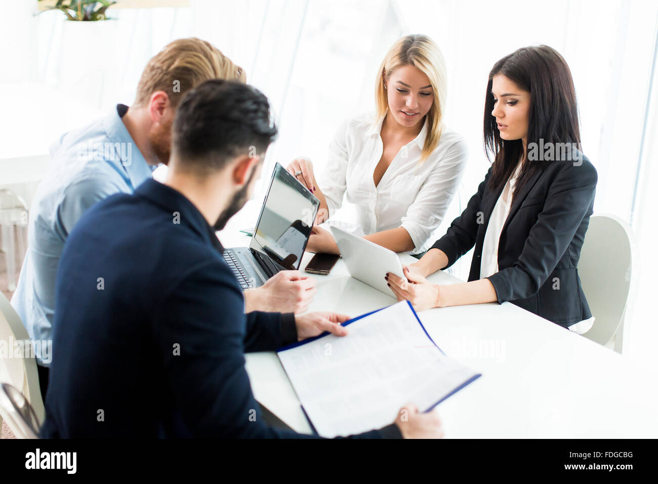 Team young people sitting in hi-res stock photography and images - Alamy