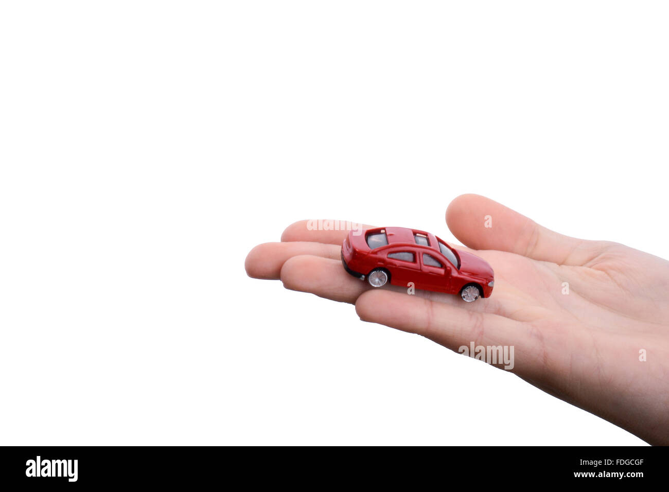 Child's hand holding a red car on a white background Stock Photo - Alamy