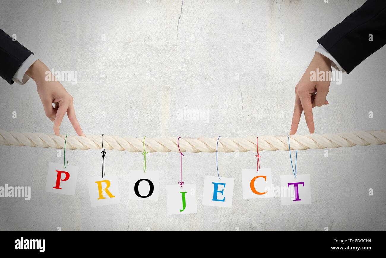 Close up of businessman hands walking with fingers on rope as ...