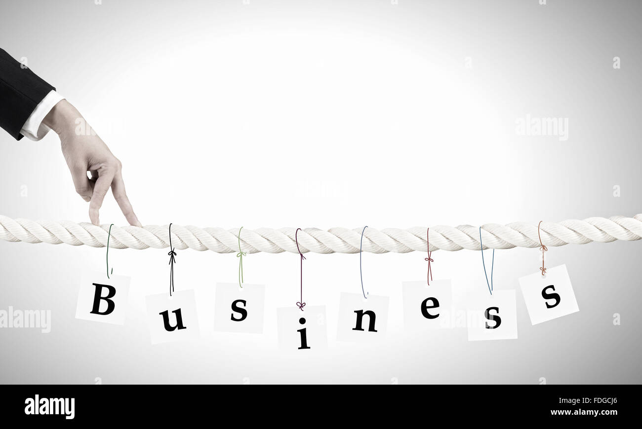 Close up of businessman hands walking with fingers on rope as ...