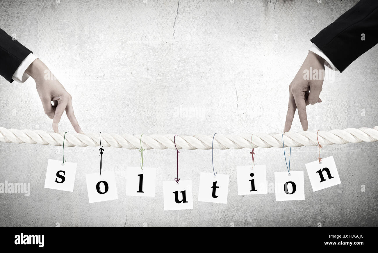 Close up of businessman hands walking with fingers on rope as ...