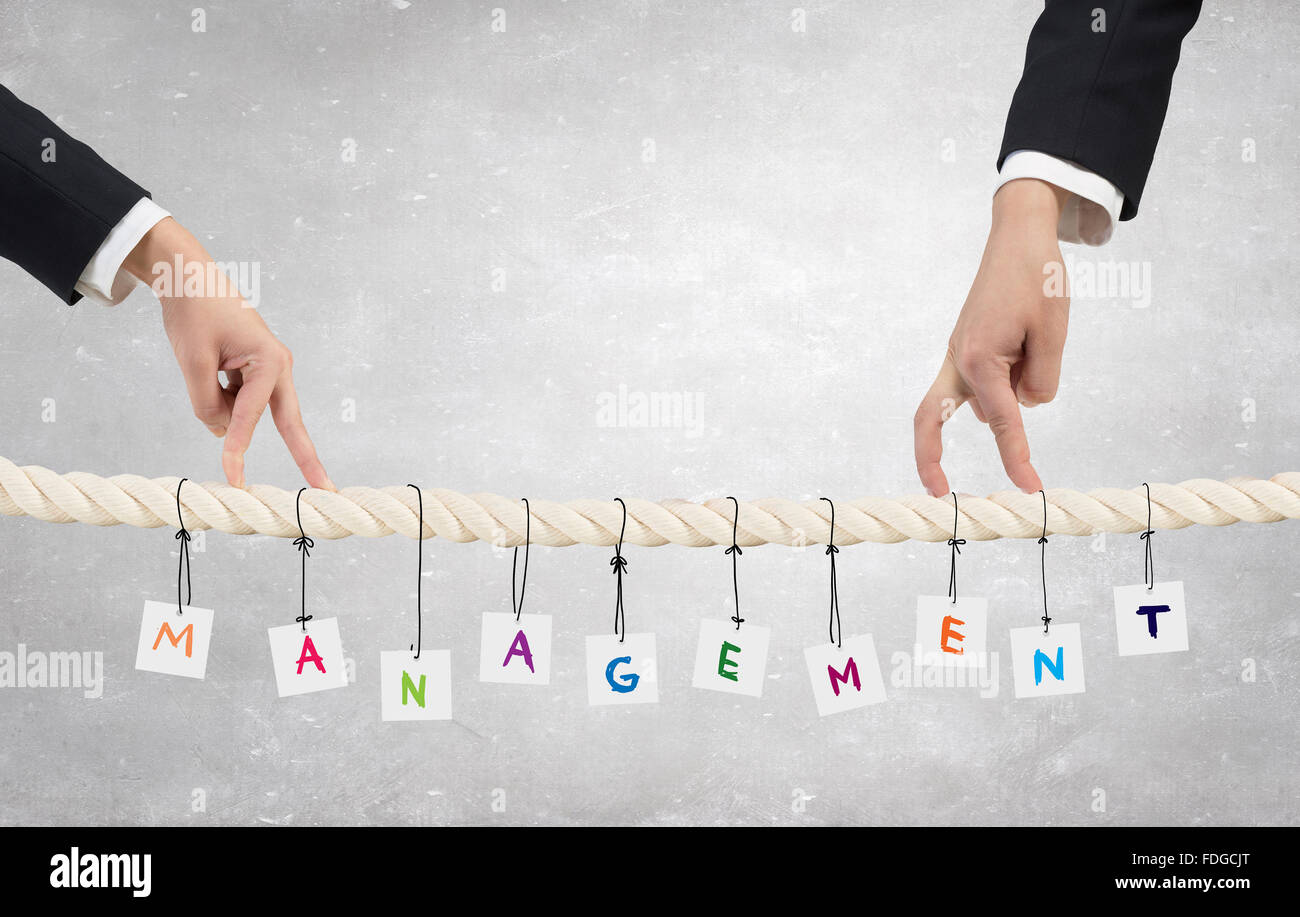 Close up of businessman hands walking with fingers on rope as ...