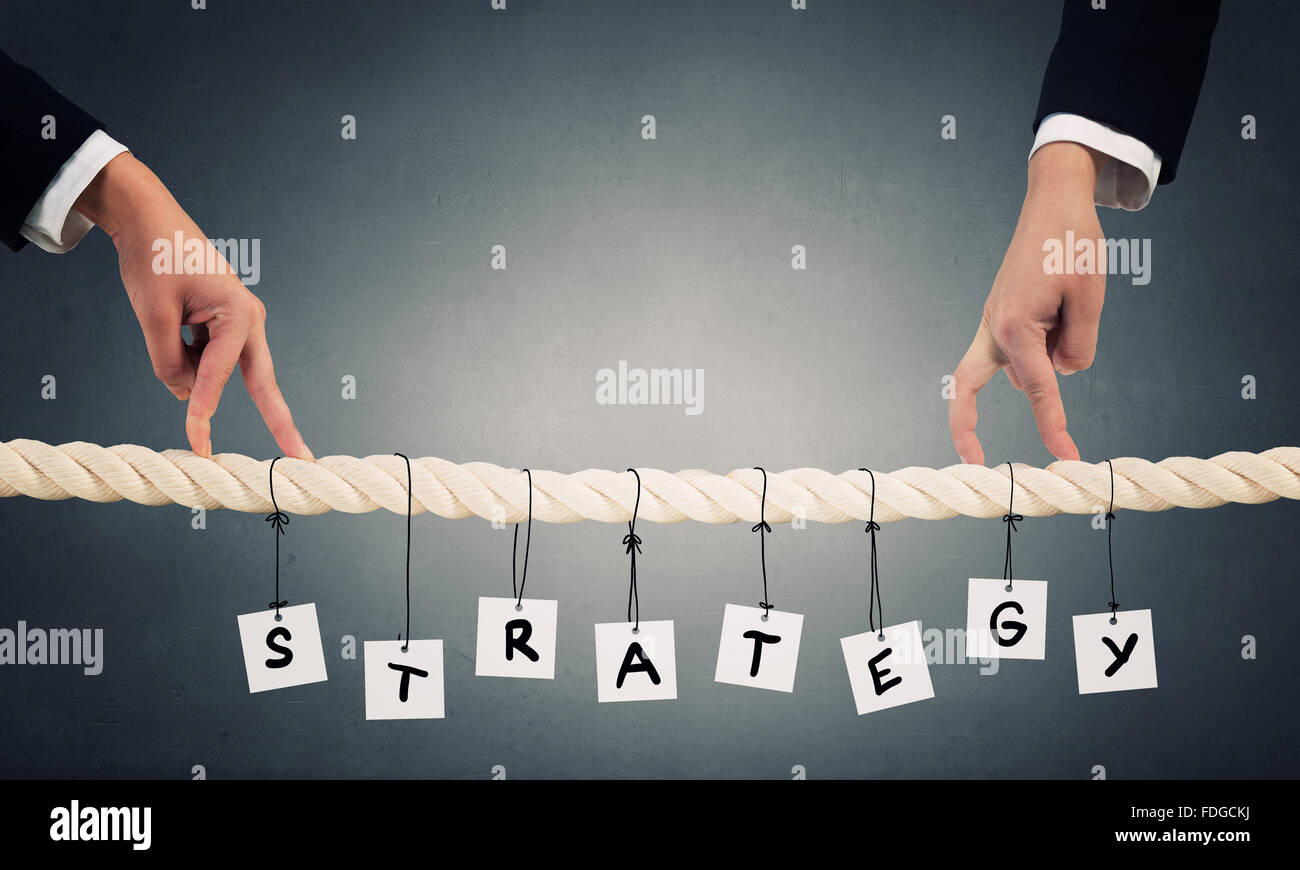 Close up of businessman hands walking with fingers on rope as ...