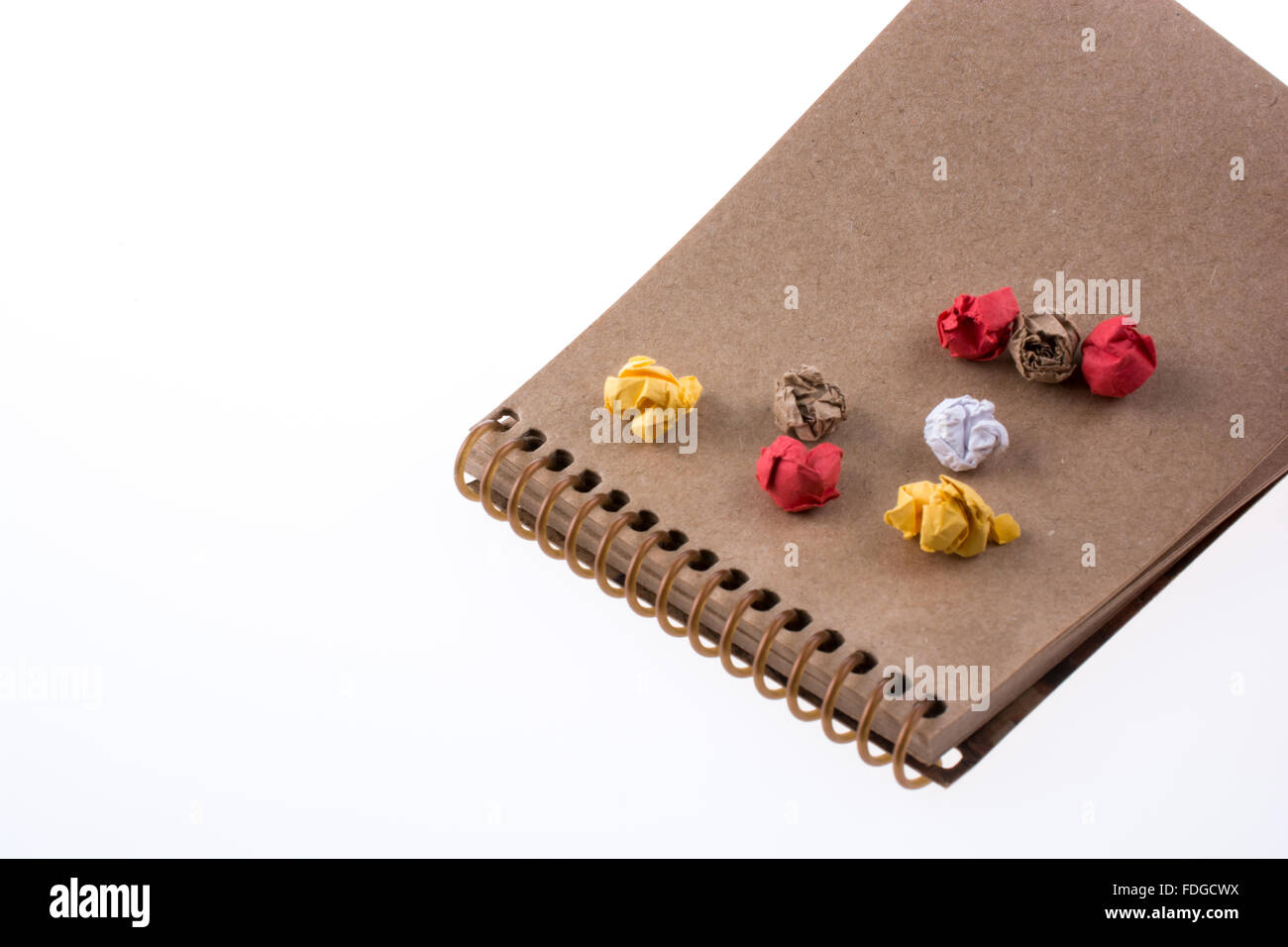 Colorful crumbled paper on a notebook on a white background Stock Photo ...