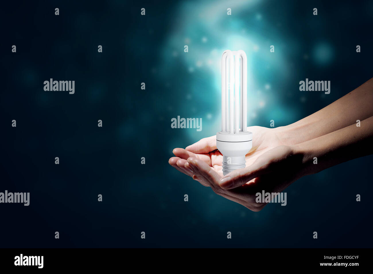 Close up of hand holding glowing light bulb Stock Photo - Alamy