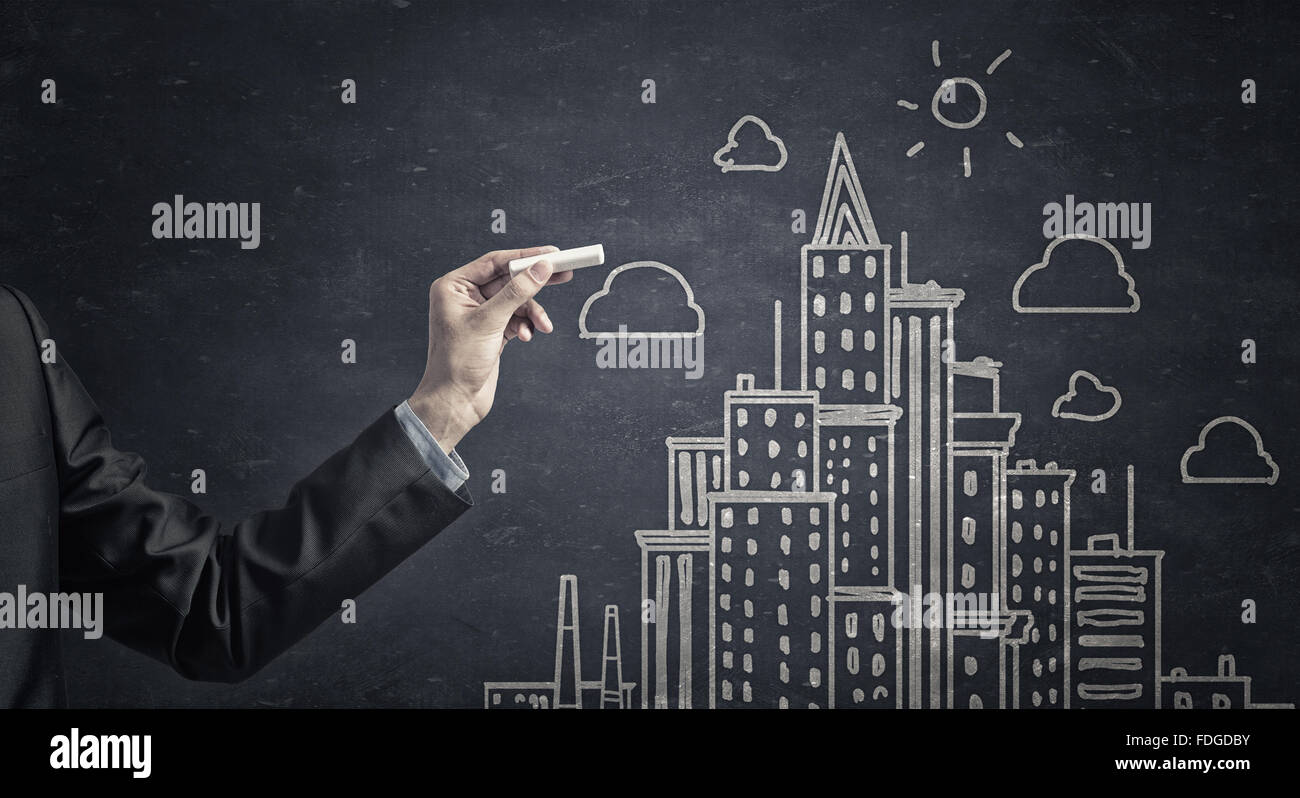 Close up of hand drawing urban city building on chalk board Stock Photo ...