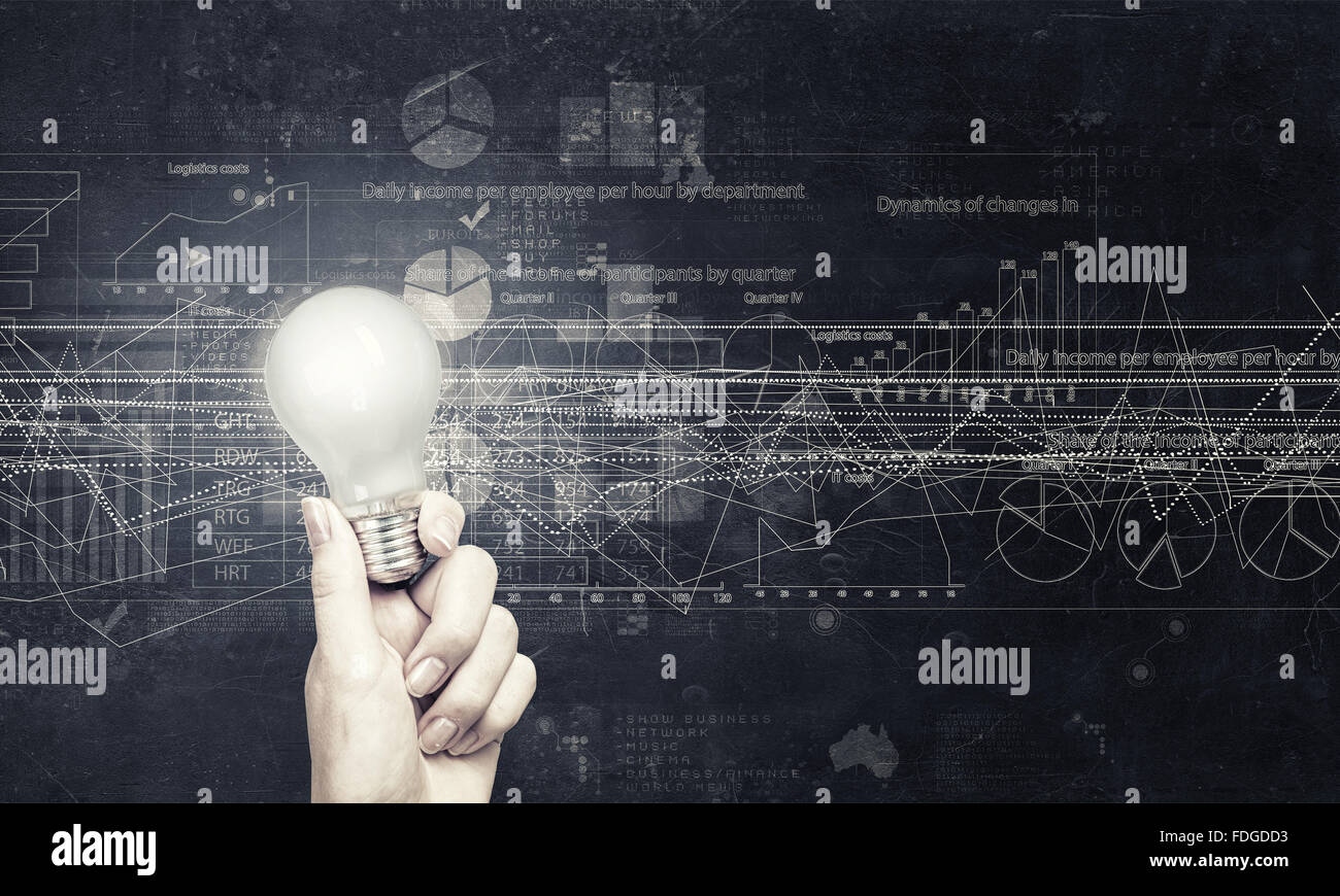 Human hand holding a shining electric bulb on digital background Stock ...