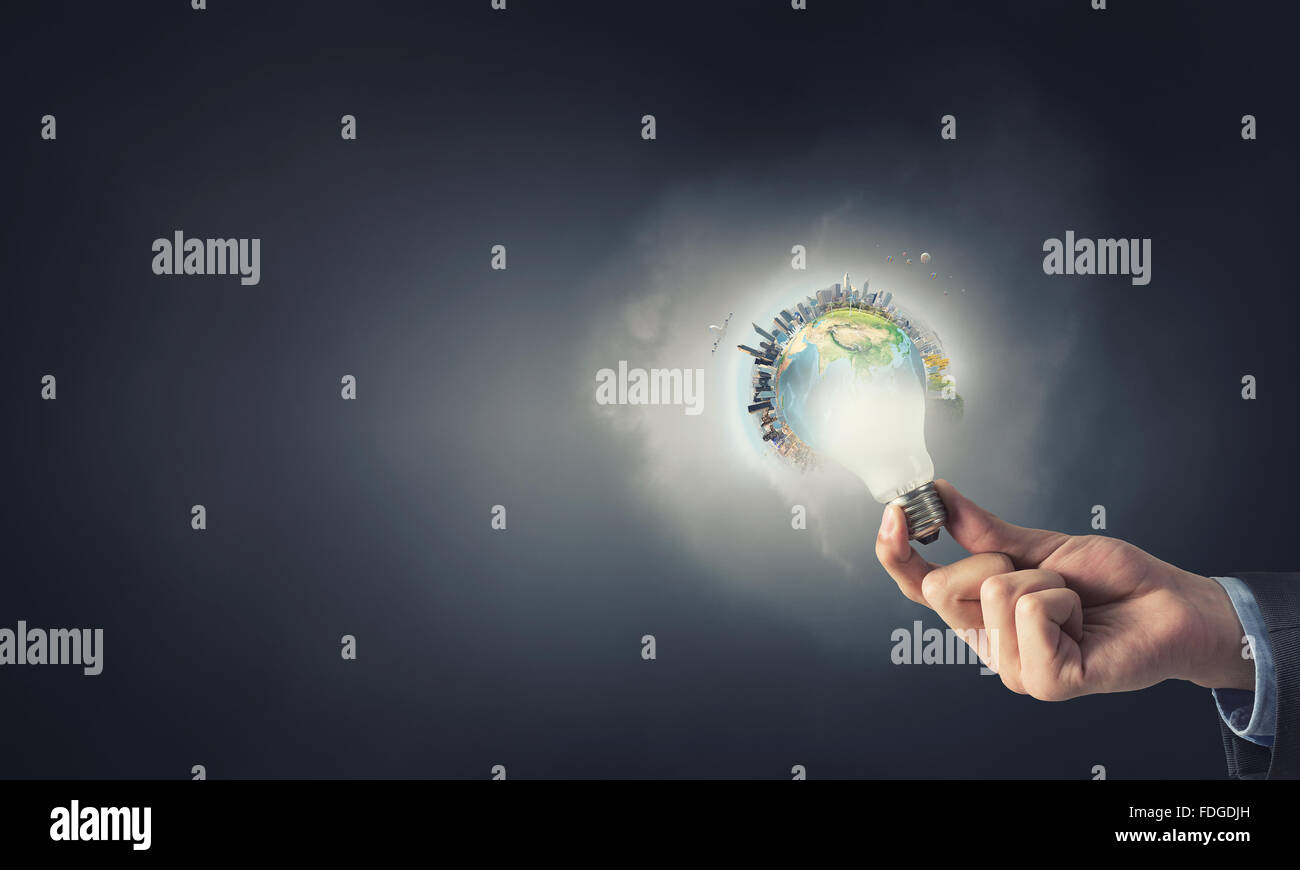 Businessman hand holding glowing light bulb. Elements of this image are ...