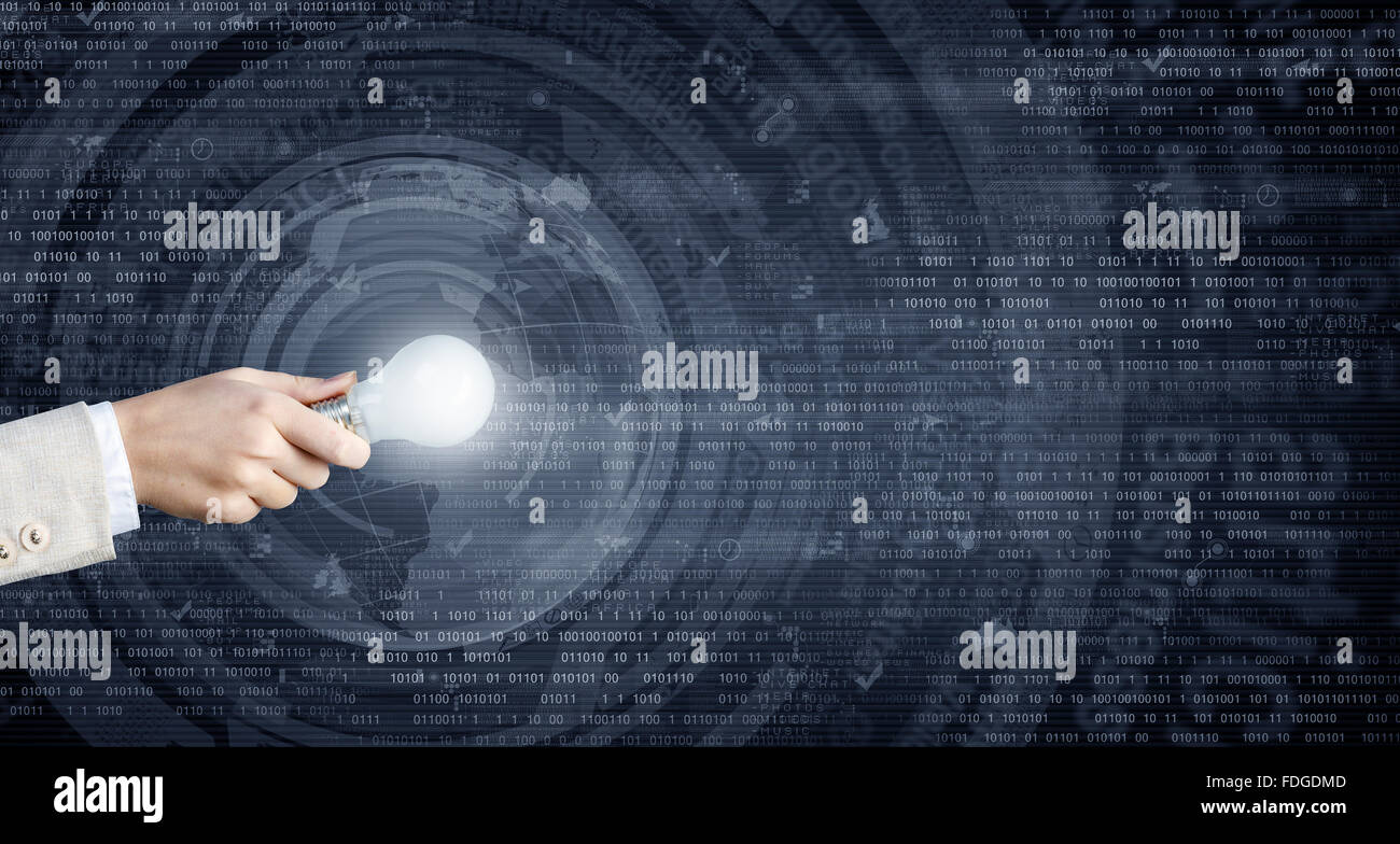 Human hand holding a shining electric bulb on digital background Stock ...