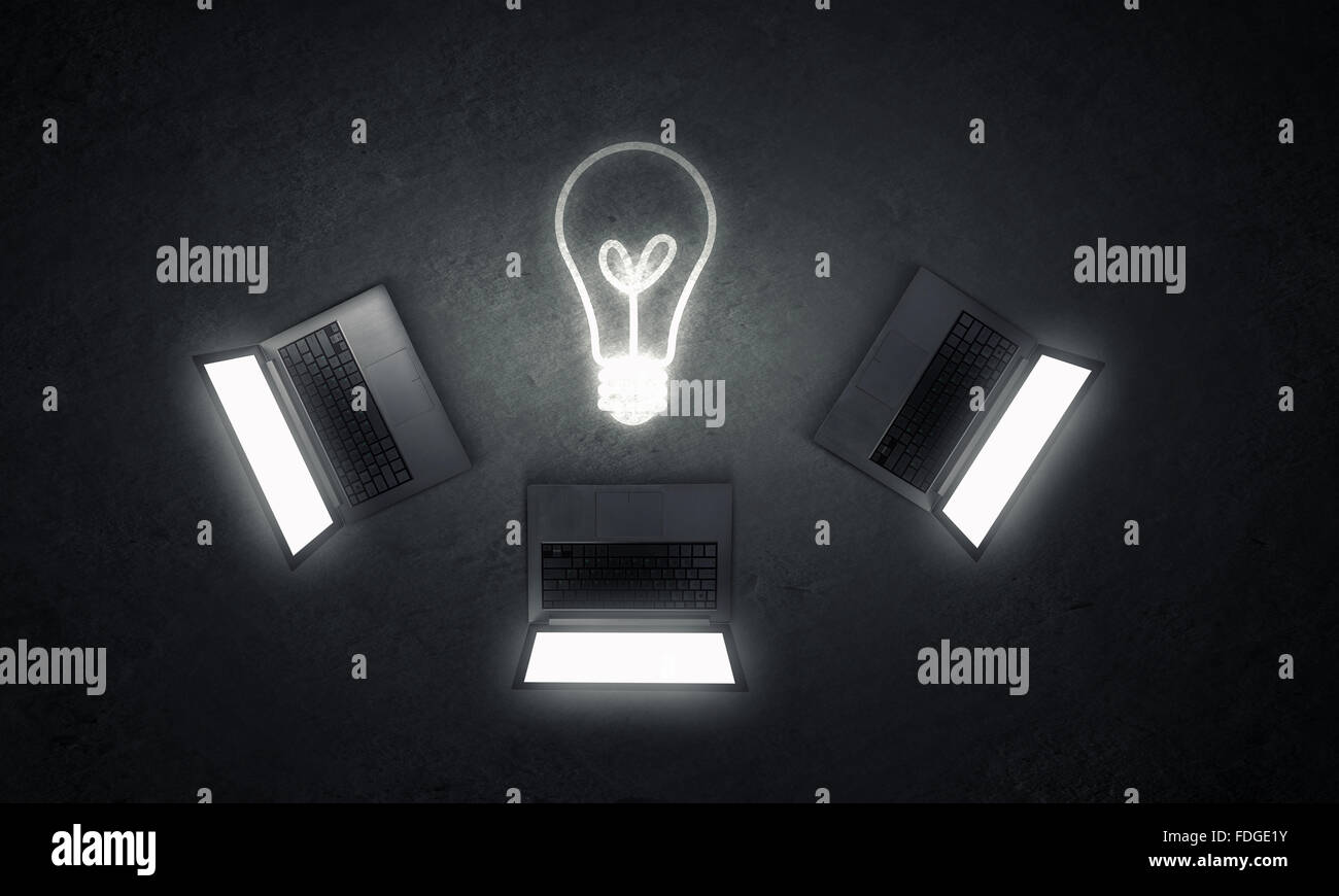 Three opened laptop computers and light bulb concept Stock Photo - Alamy
