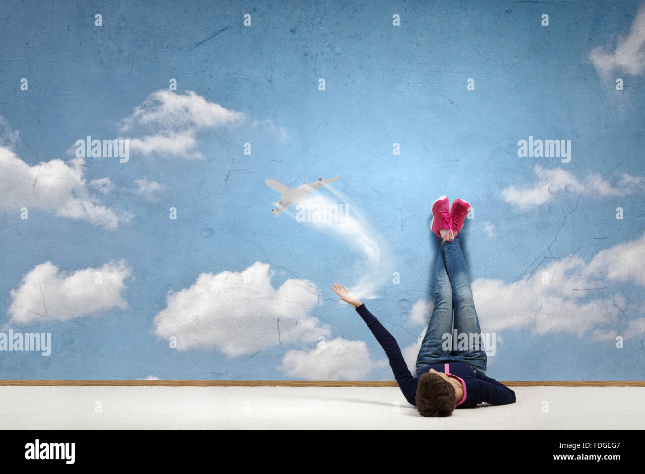 Young woman lying on floor with legs raised up Stock Photo - Alamy