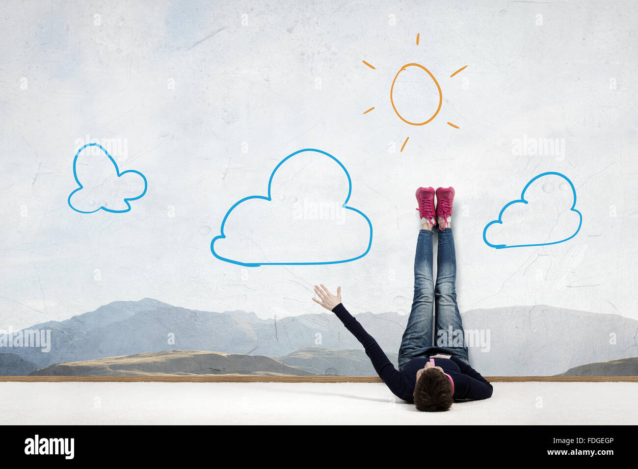 Young woman lying on floor with legs raised up Stock Photo - Alamy